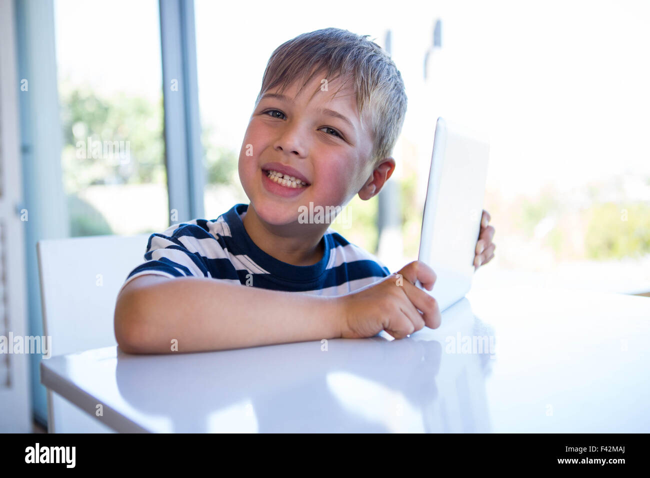 Little boy using tablet pc Stock Photo - Alamy