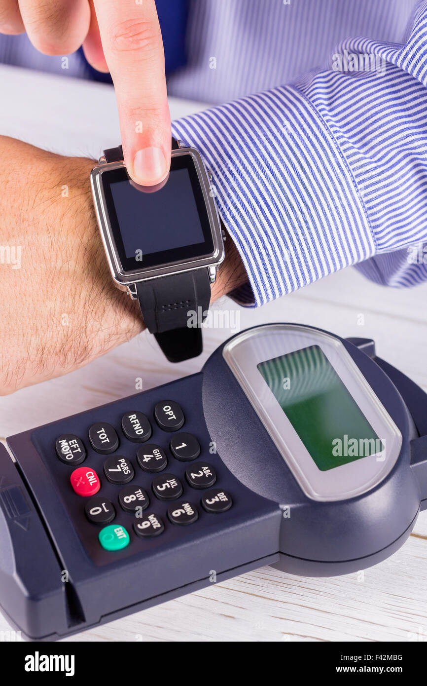 Man using smart watch to express pay Stock Photo - Alamy