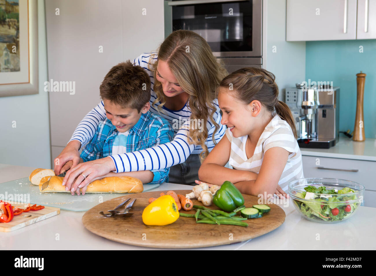 Happy family preparing lunch together Stock Photo - Alamy