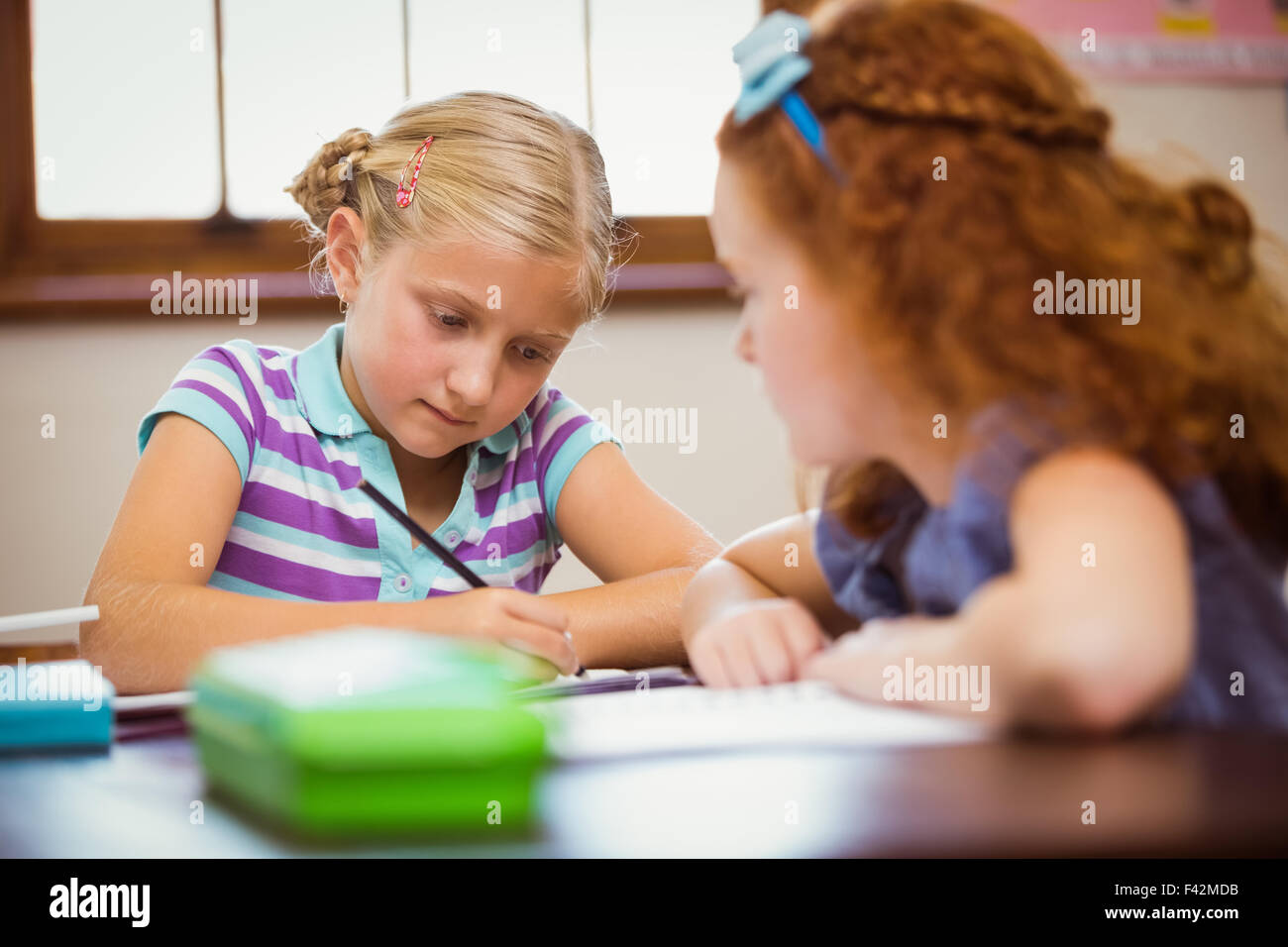 Pupils working hard at desk Stock Photo - Alamy