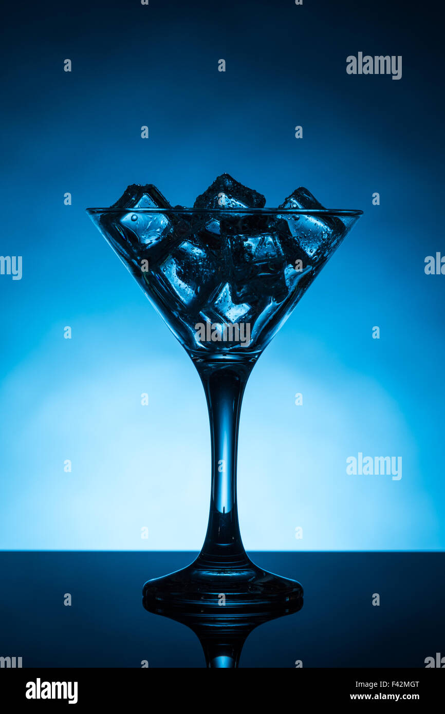 Martini glass filled with ice cubes Stock Photo - Alamy