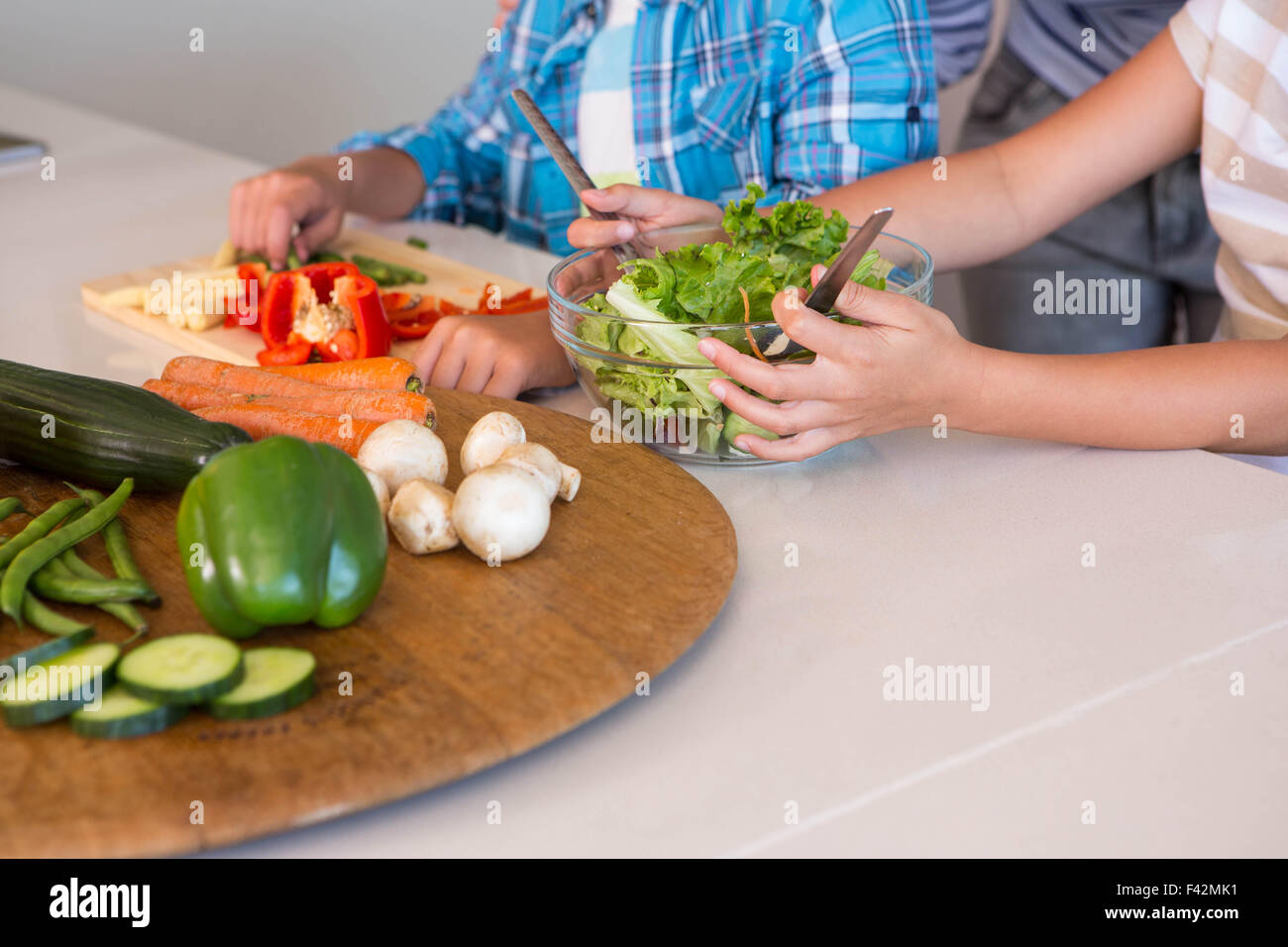 Happy family preparing lunch together Stock Photo - Alamy