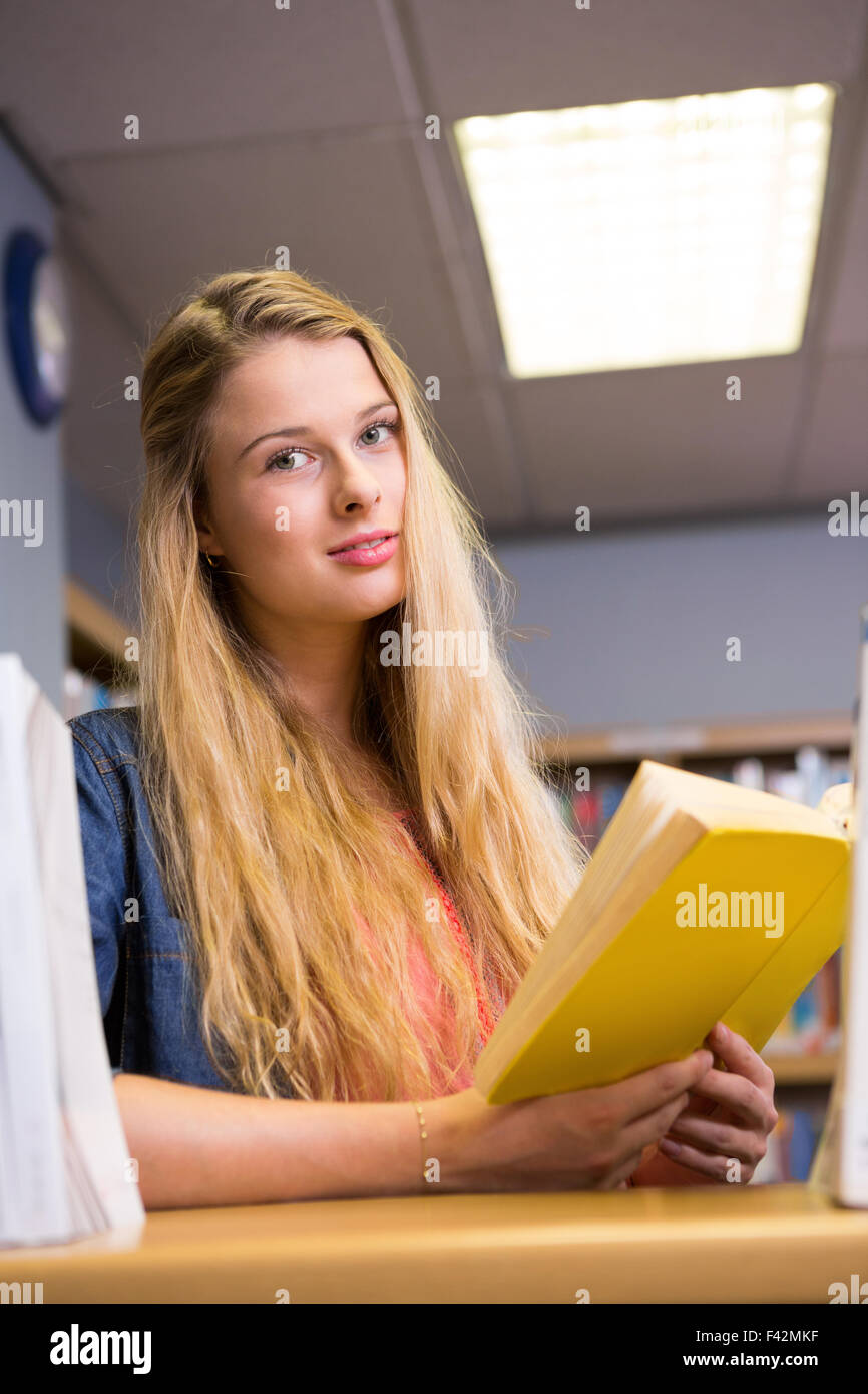 Pretty student studying in the library Stock Photo - Alamy