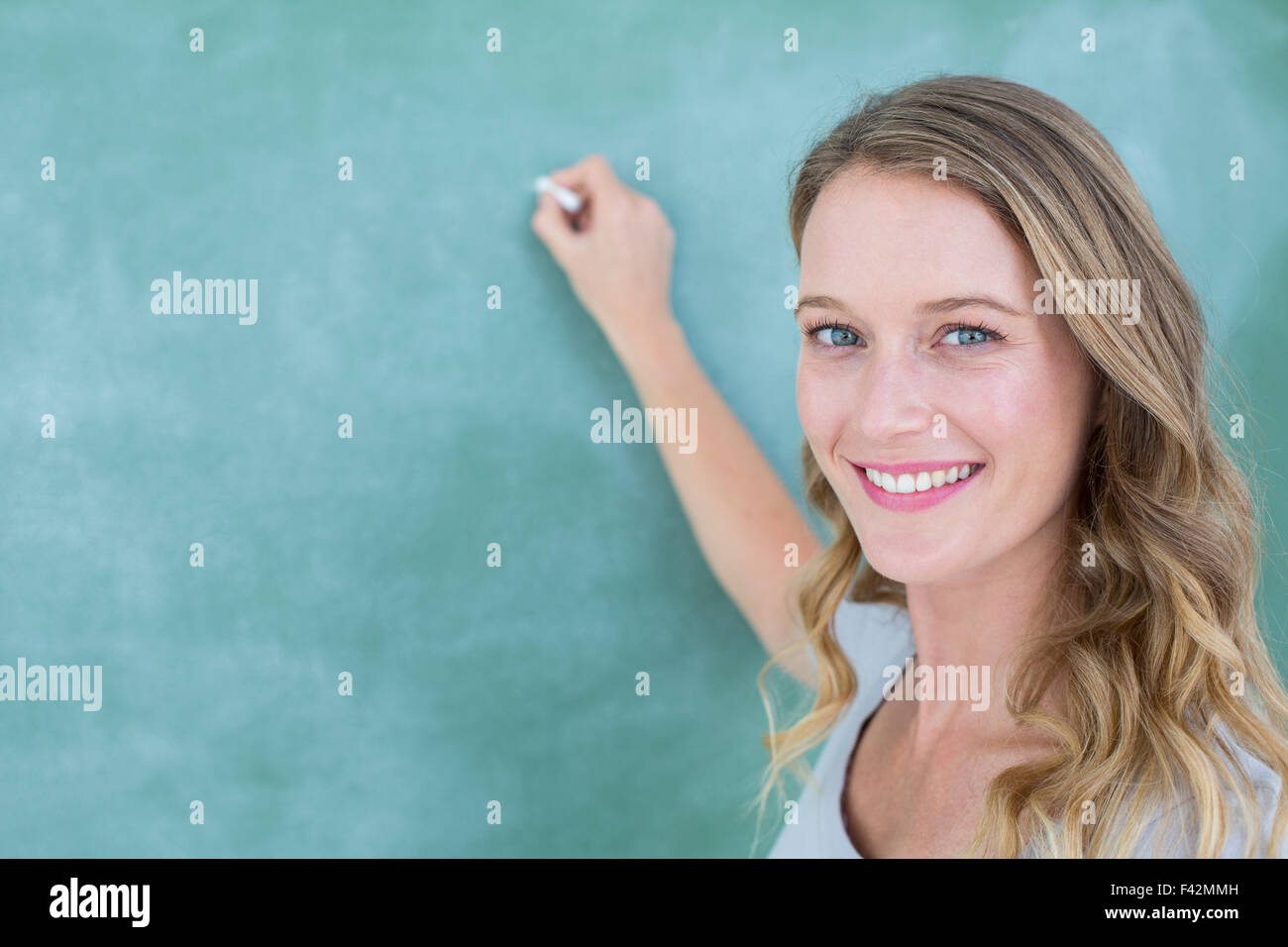 Teacher writing on blackboard hi-res stock photography and images - Alamy