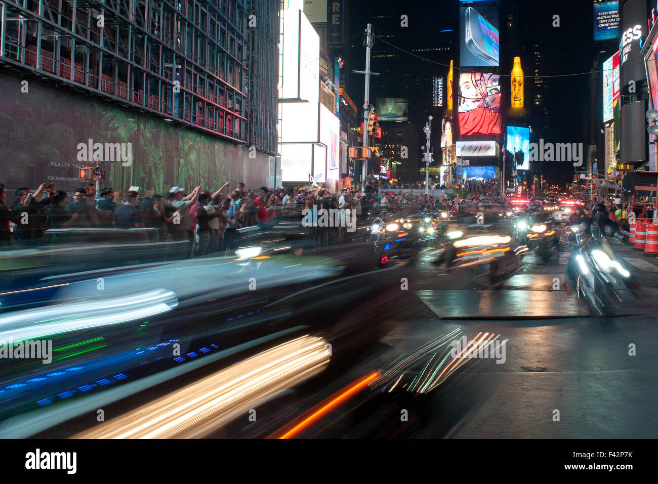 Tourists watching parade in Times Square at night, Manhattan, New York ...