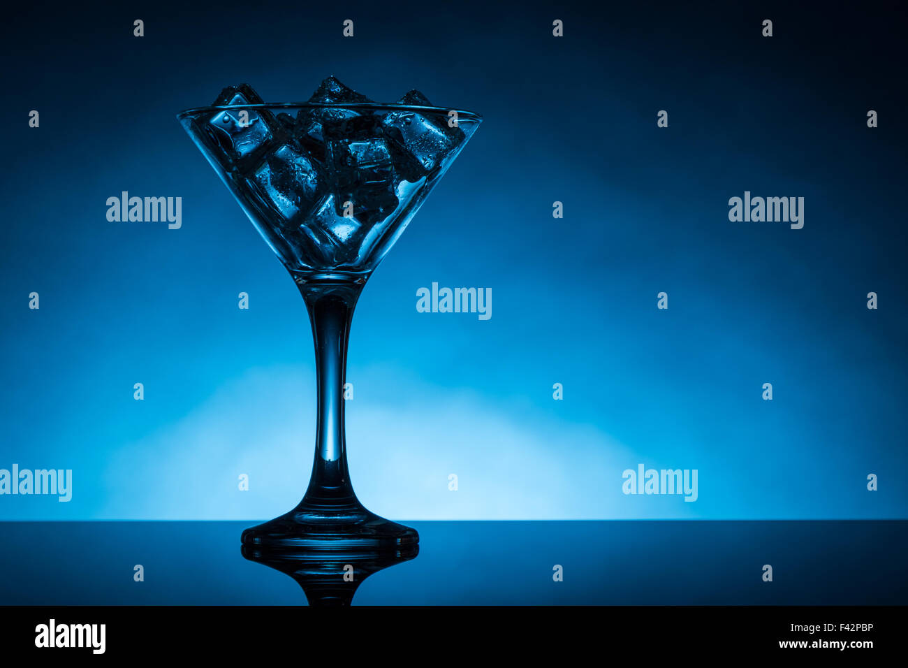 Martini glass filled with ice cubes Stock Photo - Alamy
