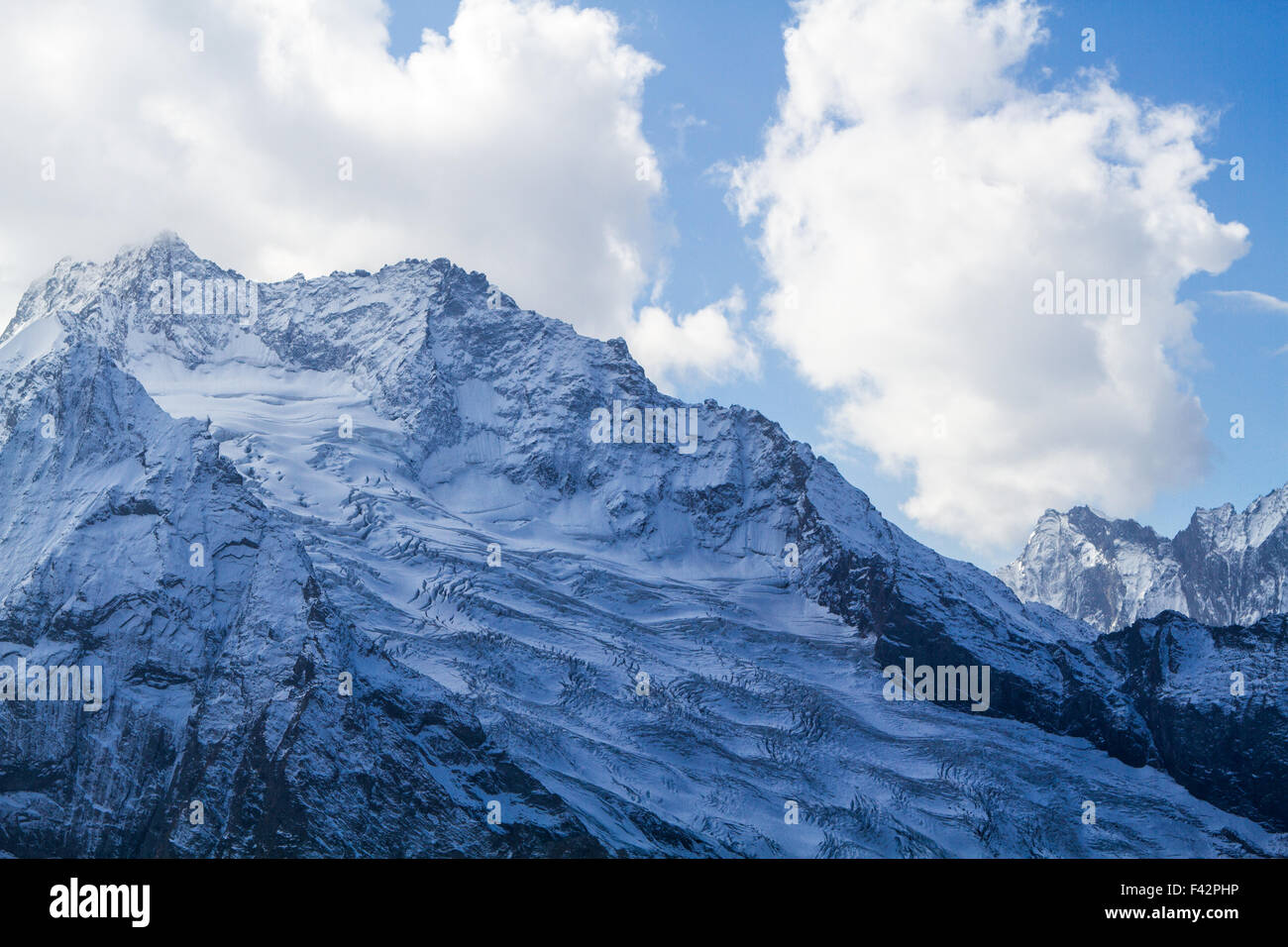 Mountain peaks with snow in the clouds hi-res stock photography and ...