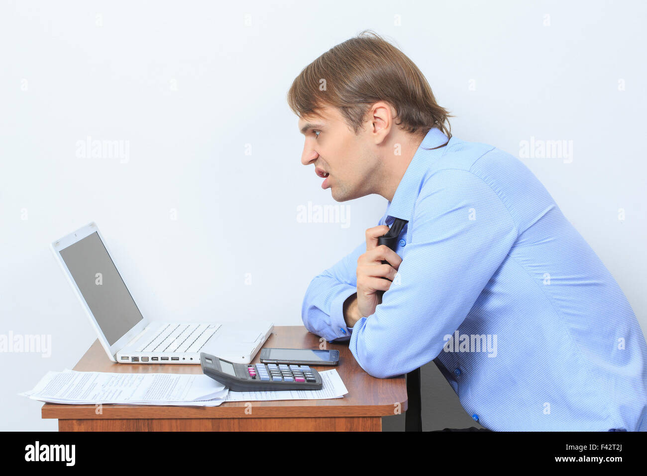 disgruntled manager at his desk Stock Photo - Alamy