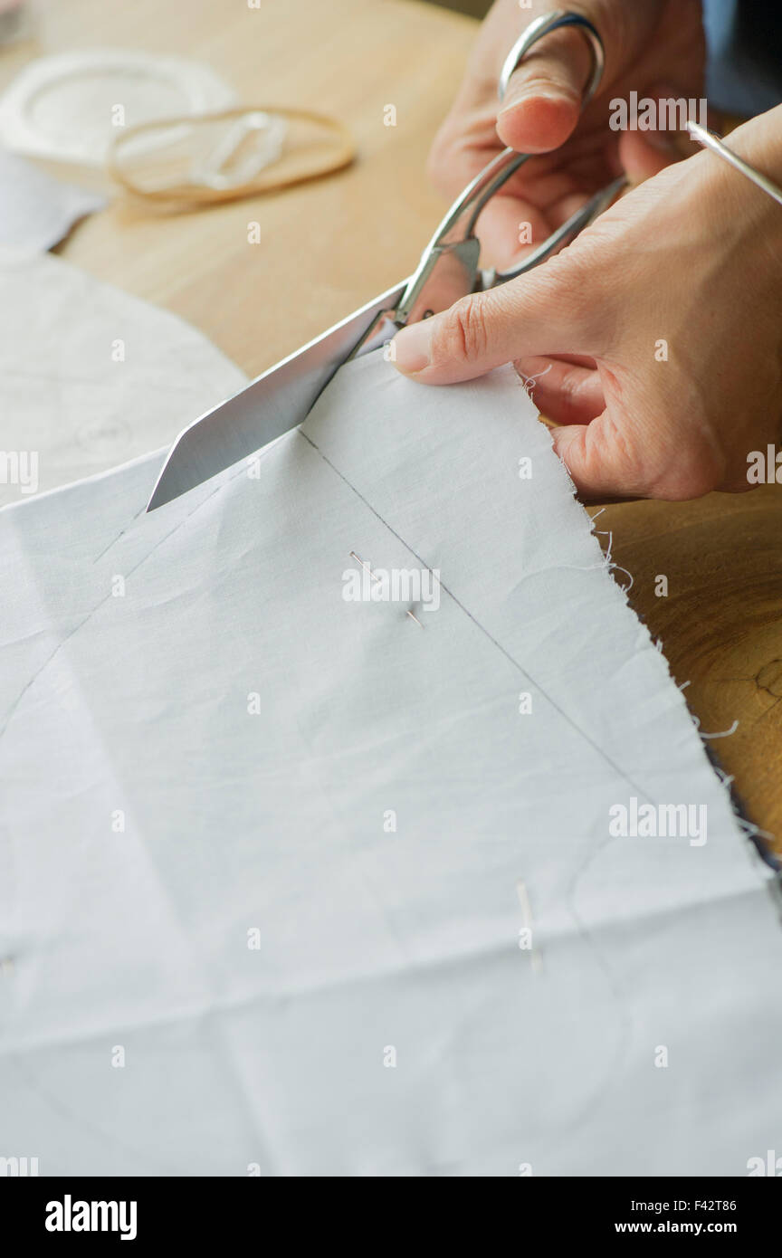 Woman cutting fabric, cropped Stock Photo - Alamy