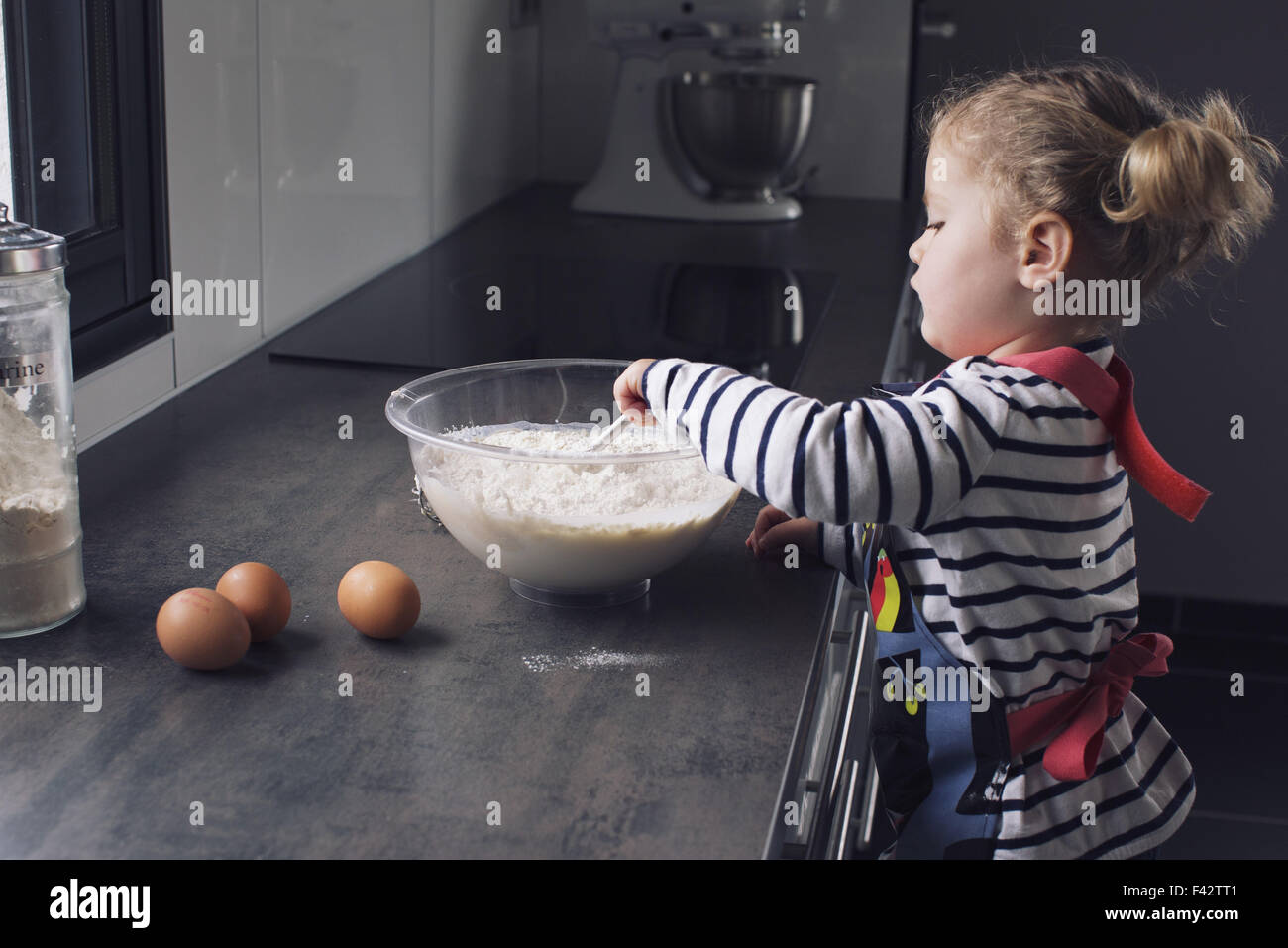 Little girl mixing batter Stock Photo - Alamy