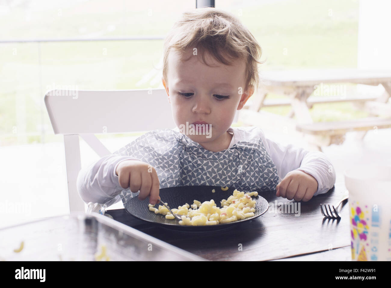 Little boy eating macaroni Stock Photo - Alamy