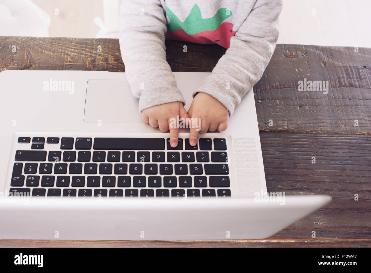 Child's hands on laptop computer keyboard Stock Photo - Alamy