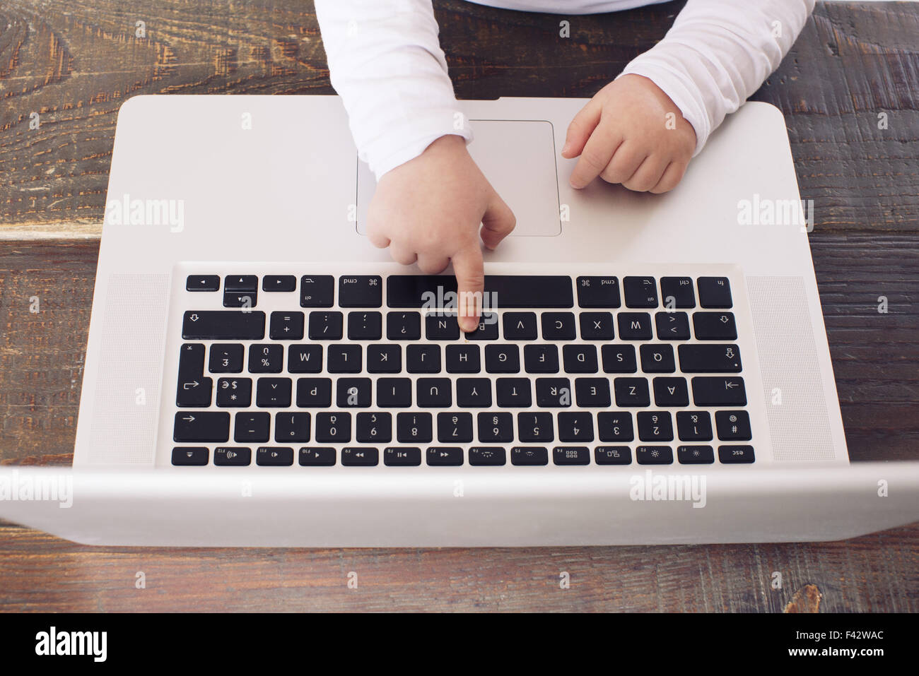 Child using laptop computer, cropped Stock Photo - Alamy