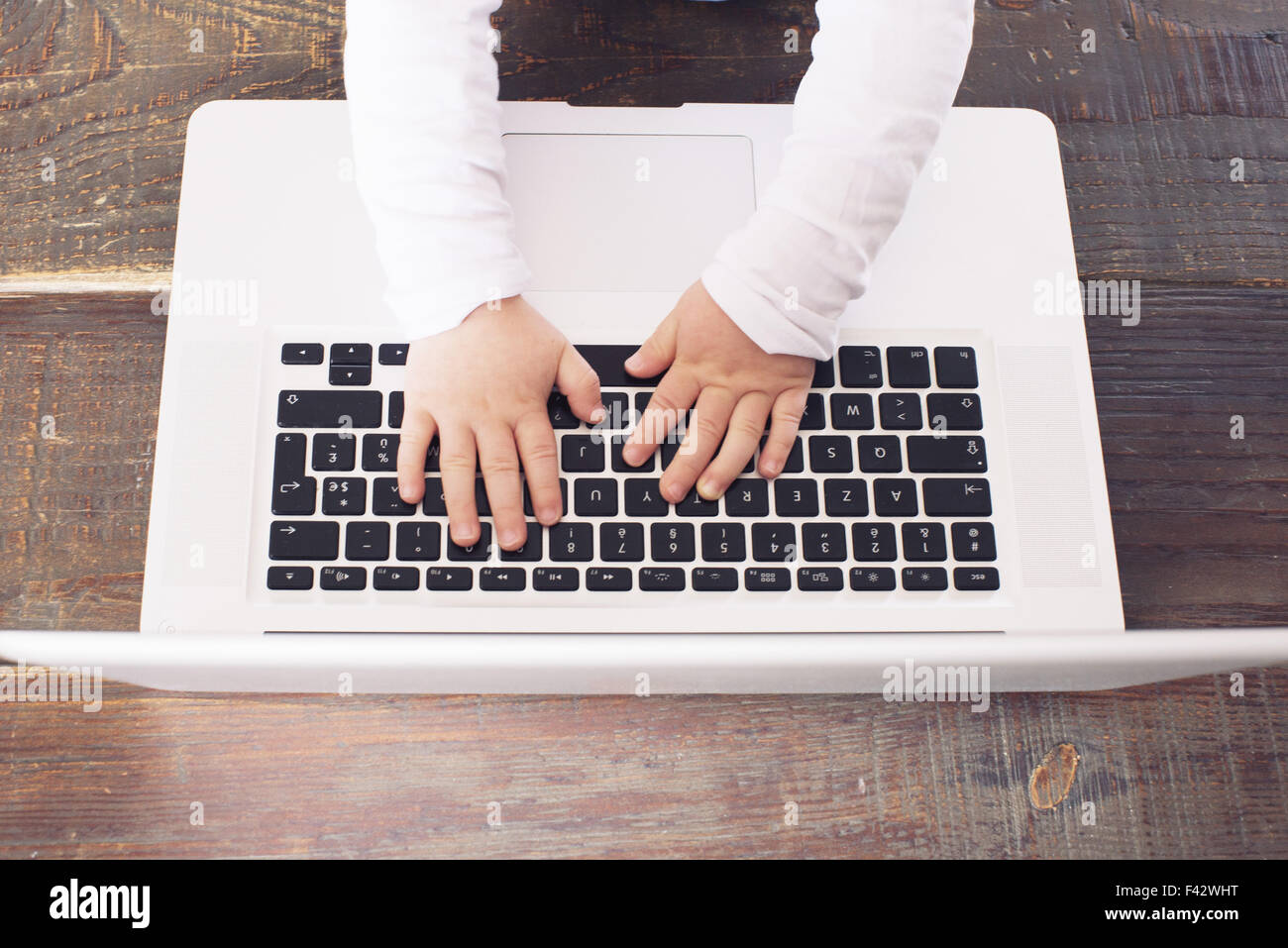 Child's hands on laptop computer keyboard Stock Photo - Alamy