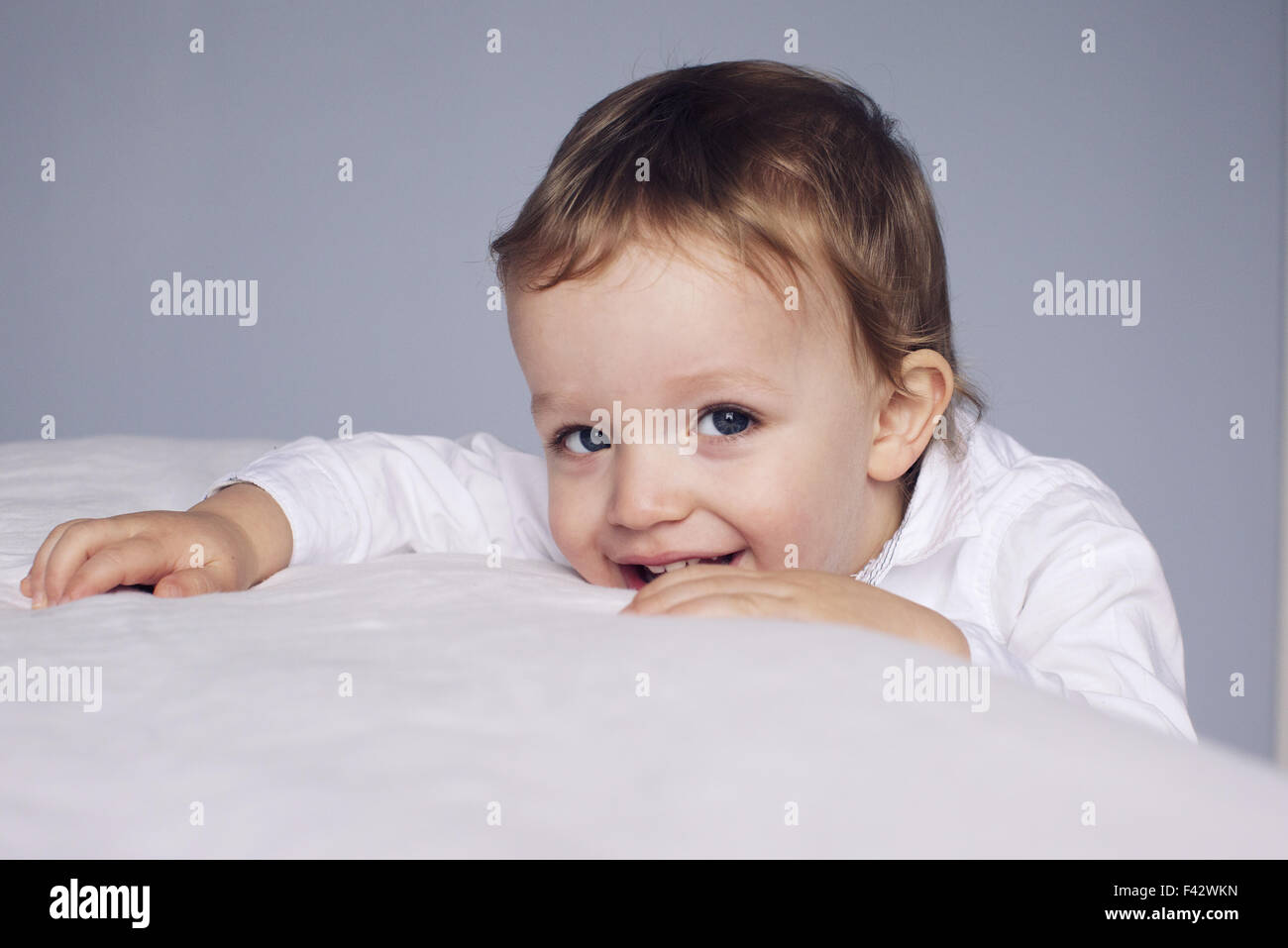 Little boy resting head on bed, portrait Stock Photo - Alamy
