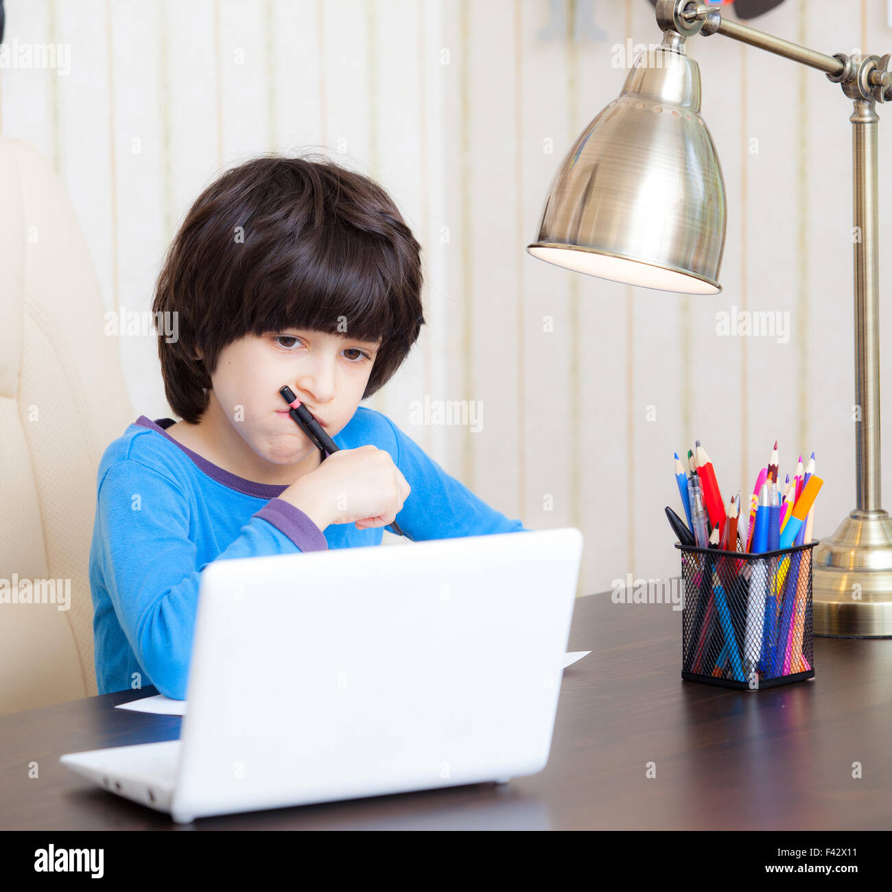 boy doing homework with computer Stock Photo - Alamy
