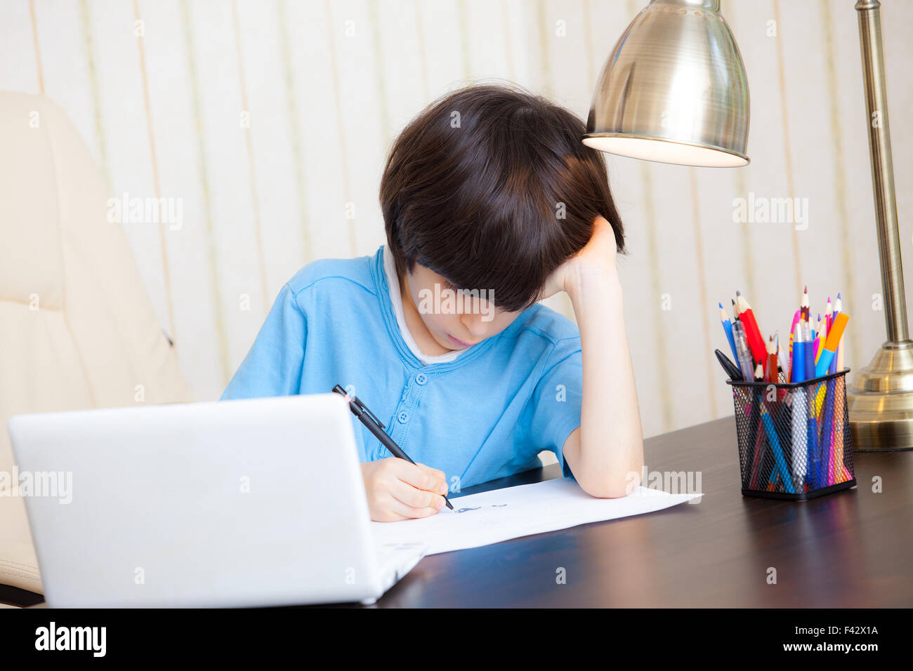 schoolboy doing homework Stock Photo - Alamy