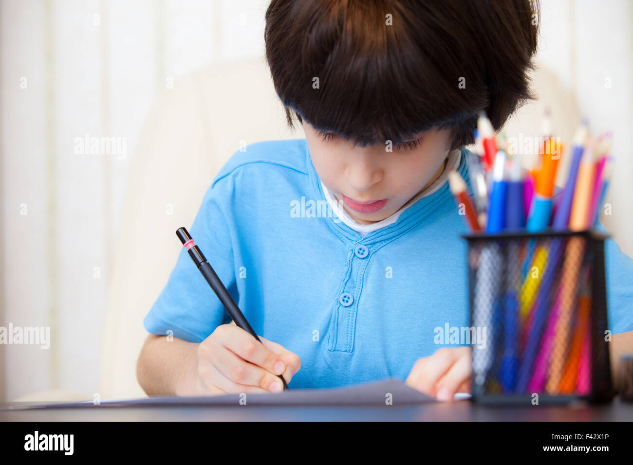 Boy doing homework Stock Photo - Alamy