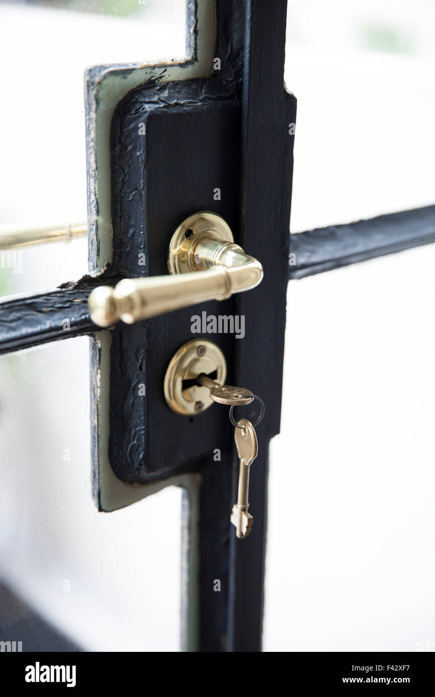 Key in door lock, close-up Stock Photo - Alamy