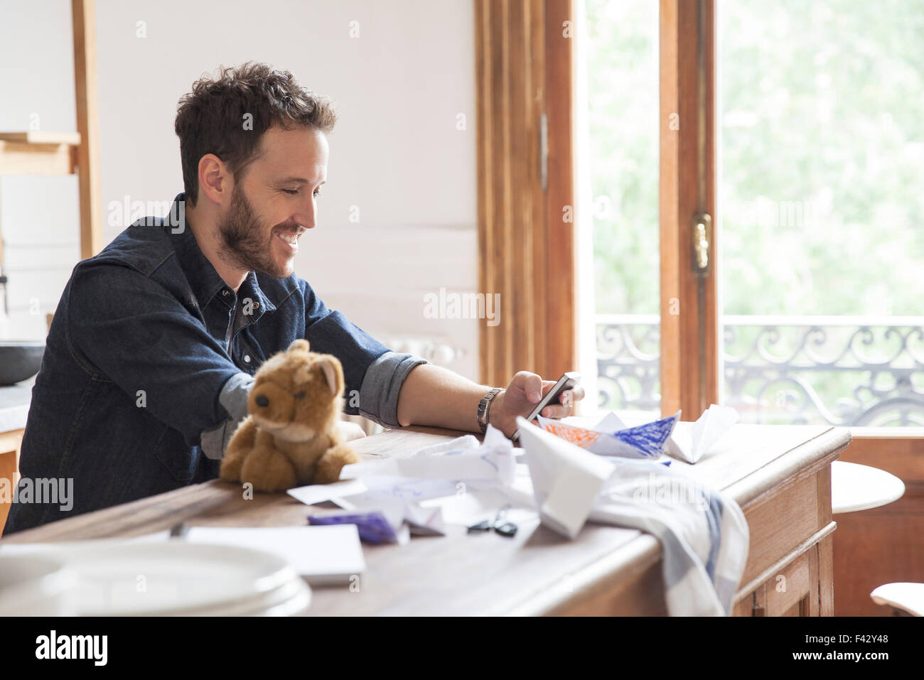 Man at home using smartphone Stock Photo - Alamy