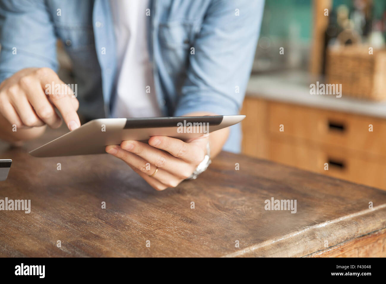 Man using wireless device at home Stock Photo - Alamy