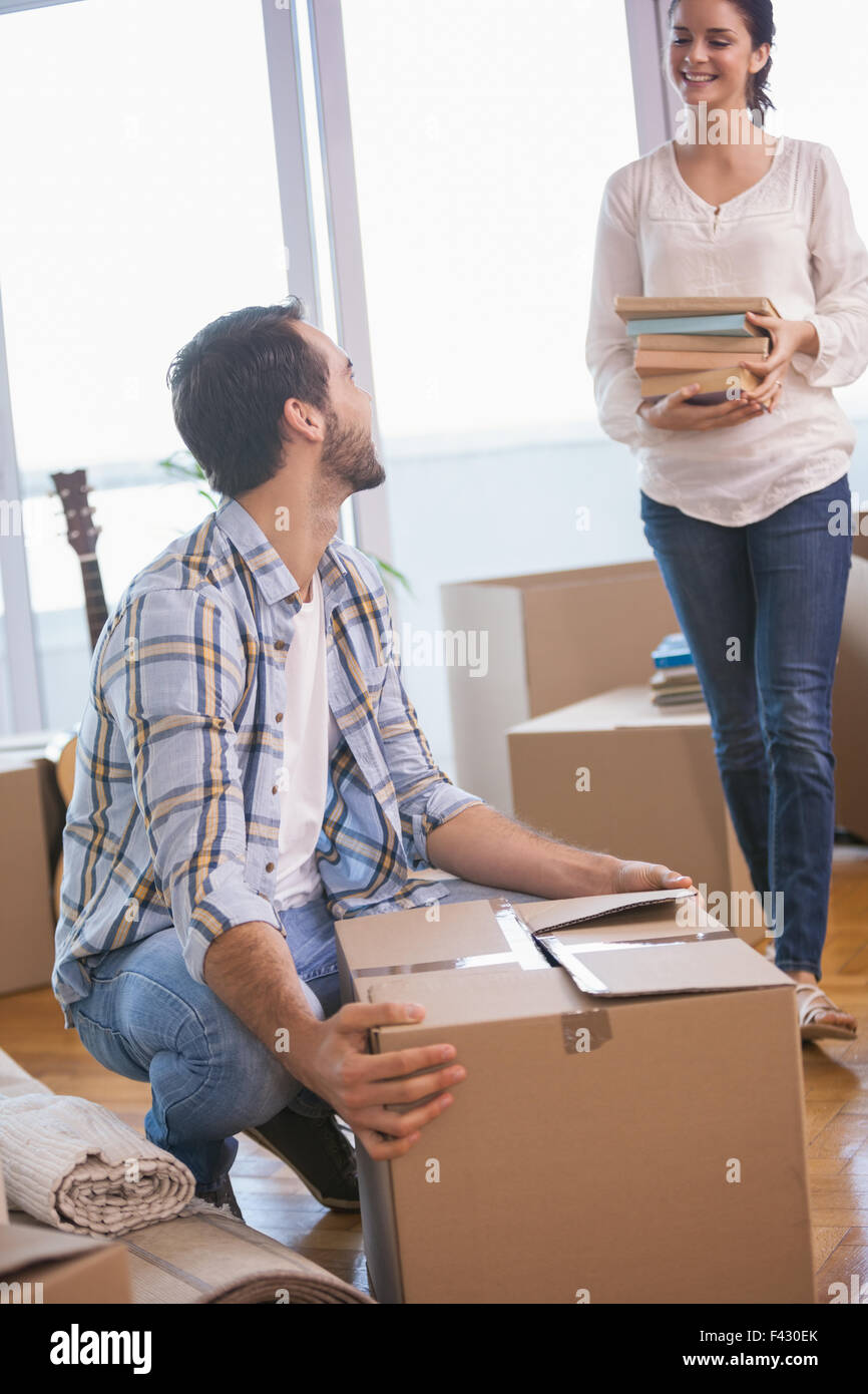 Smiling couple unpacking cardboard boxes Stock Photo - Alamy