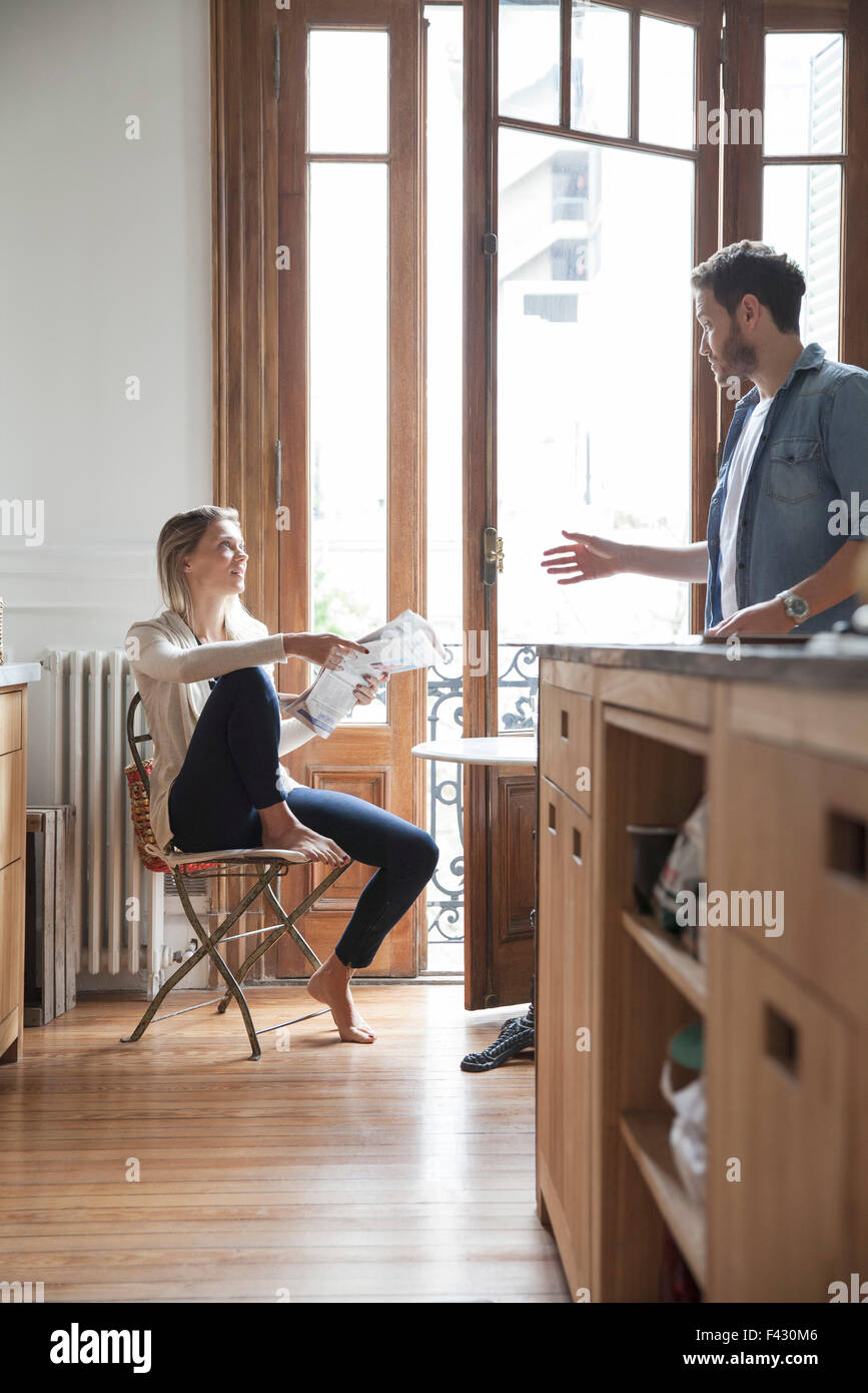 Couple chatting in kitchen Stock Photo - Alamy