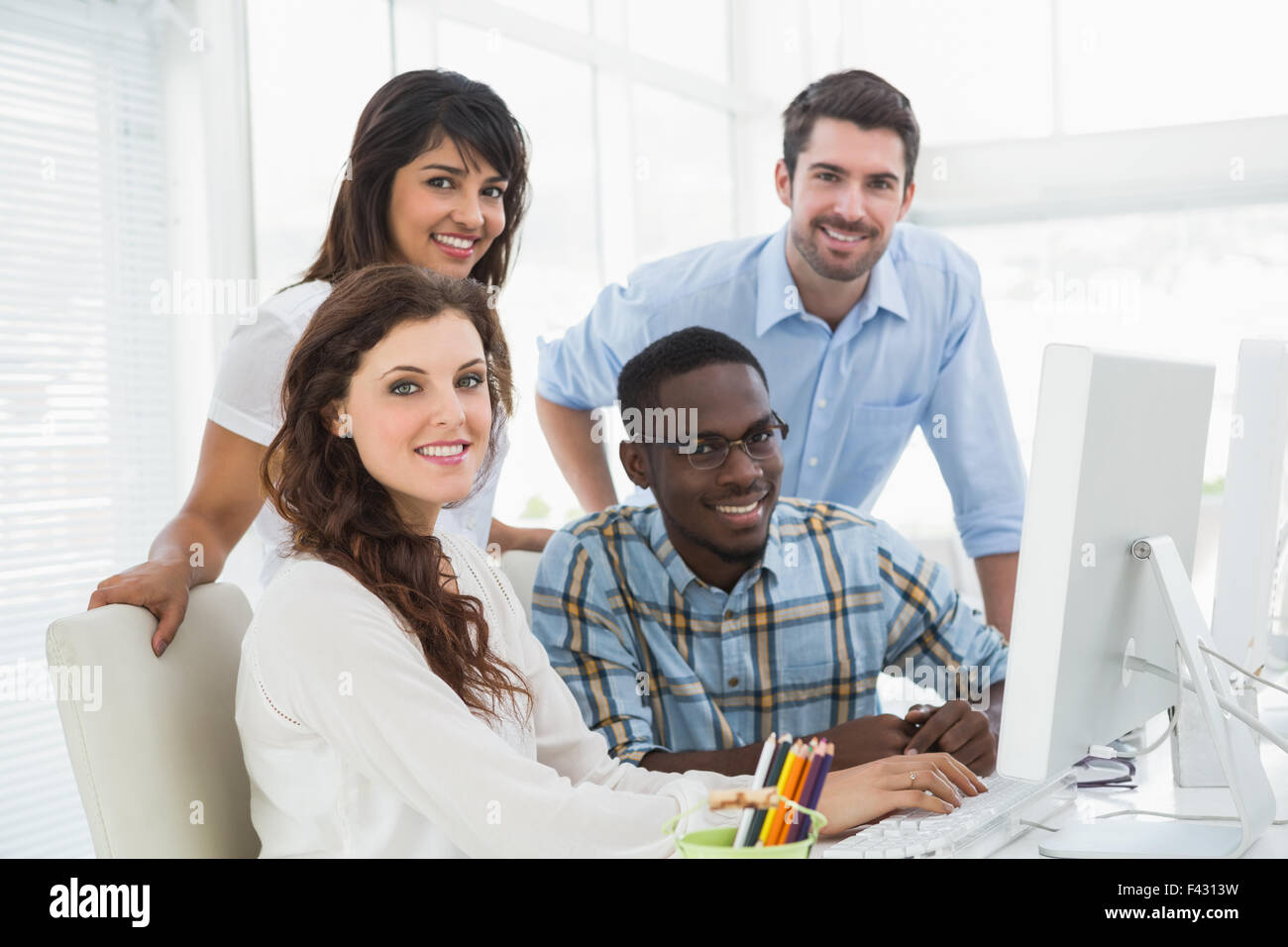 Smiling business people using computer Stock Photo - Alamy
