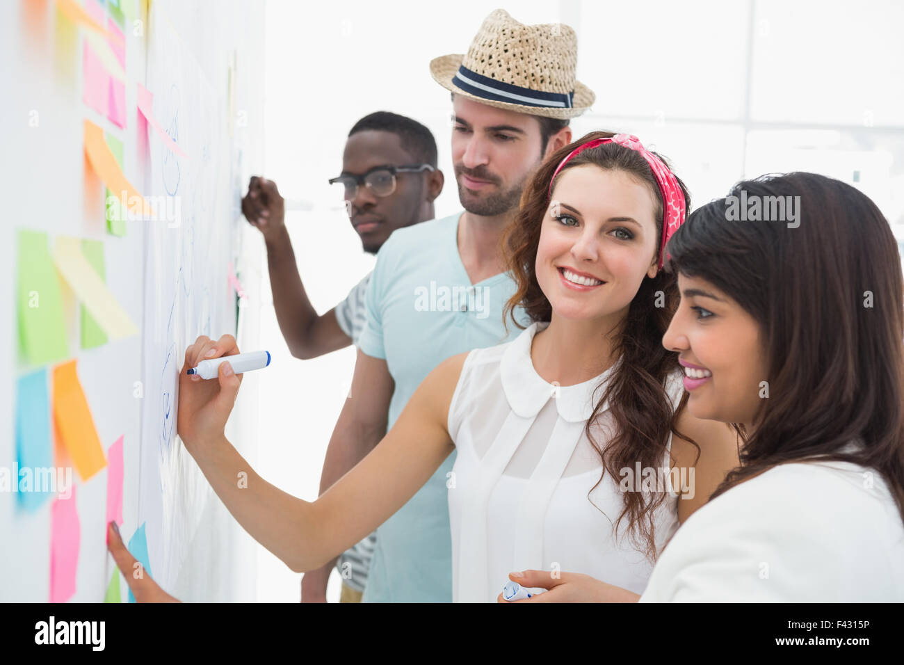 Cheerful colleagues speaking together Stock Photo - Alamy