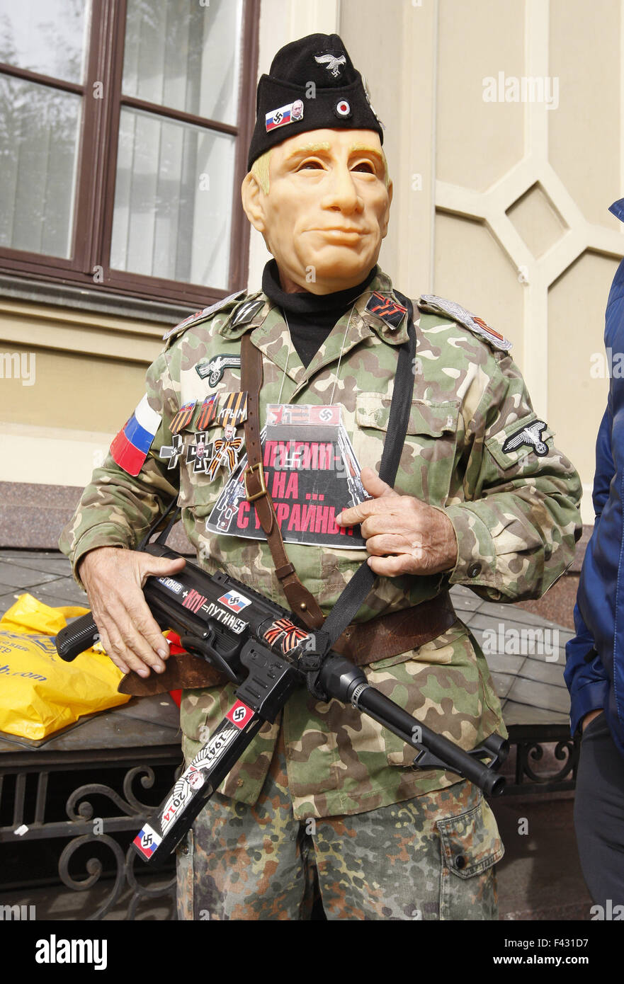 Kiev, Ukraine. 14th October, 2015. An activist wearing a mask depicting ...