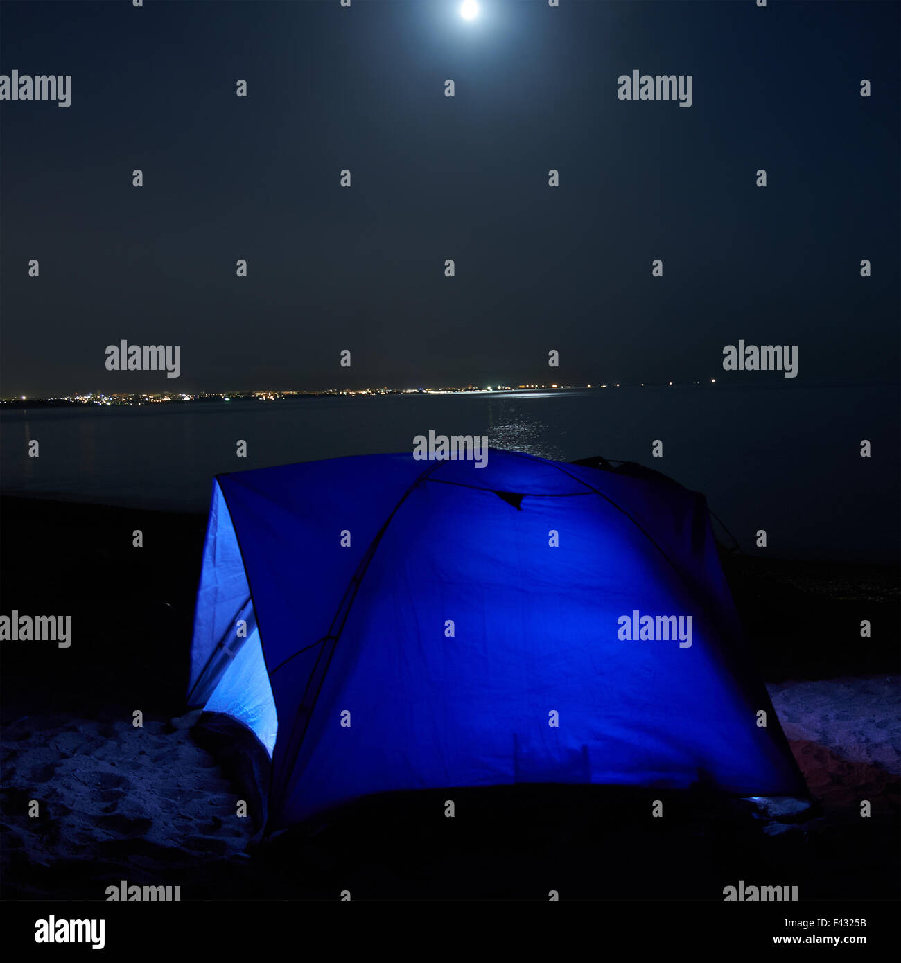 Blue illuminated tent at night Stock Photo - Alamy