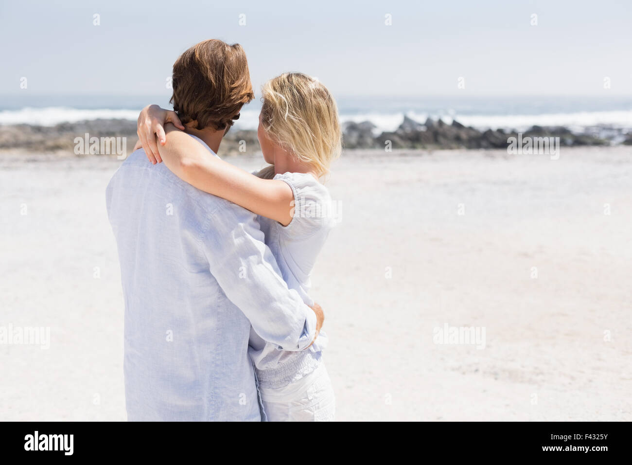 Cute couple hugging on the beach Stock Photo - Alamy