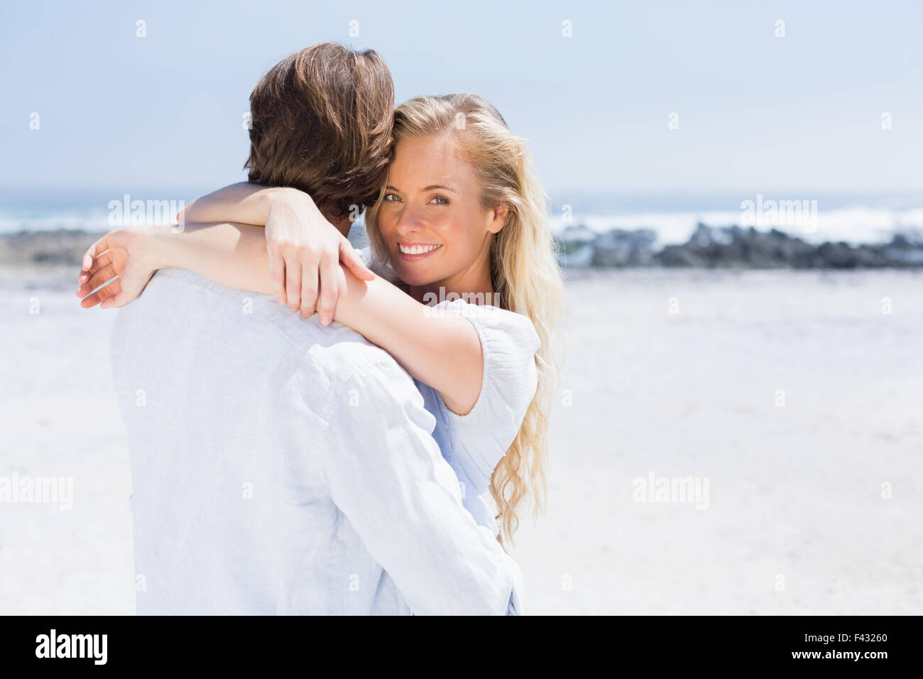 Cute couple hugging on the beach Stock Photo - Alamy