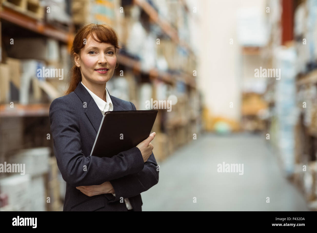 Portrait of pretty manager holding folder Stock Photo - Alamy