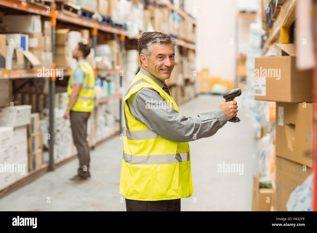 Warehouse worker scanning barcode on box Stock Photo - Alamy