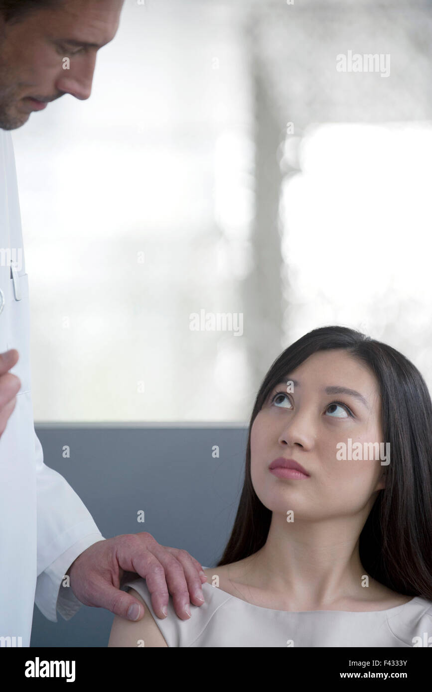 Doctor speaking with concerned patient Stock Photo - Alamy