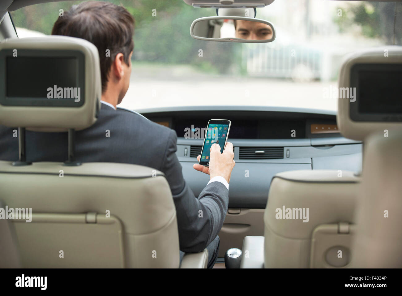 Using smartphone while driving Stock Photo - Alamy