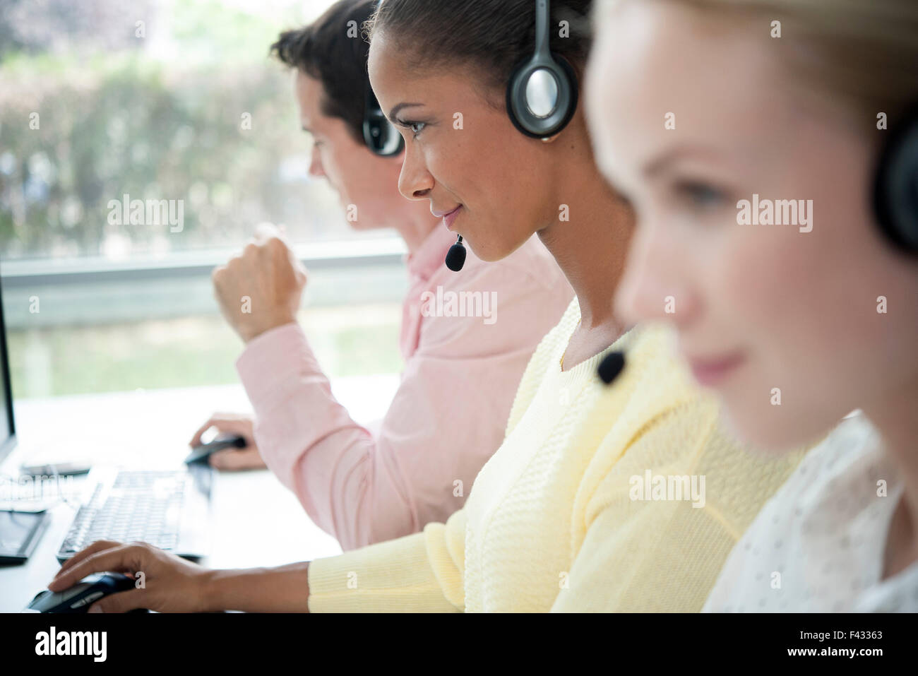 Telemarketers at work in call center Stock Photo - Alamy