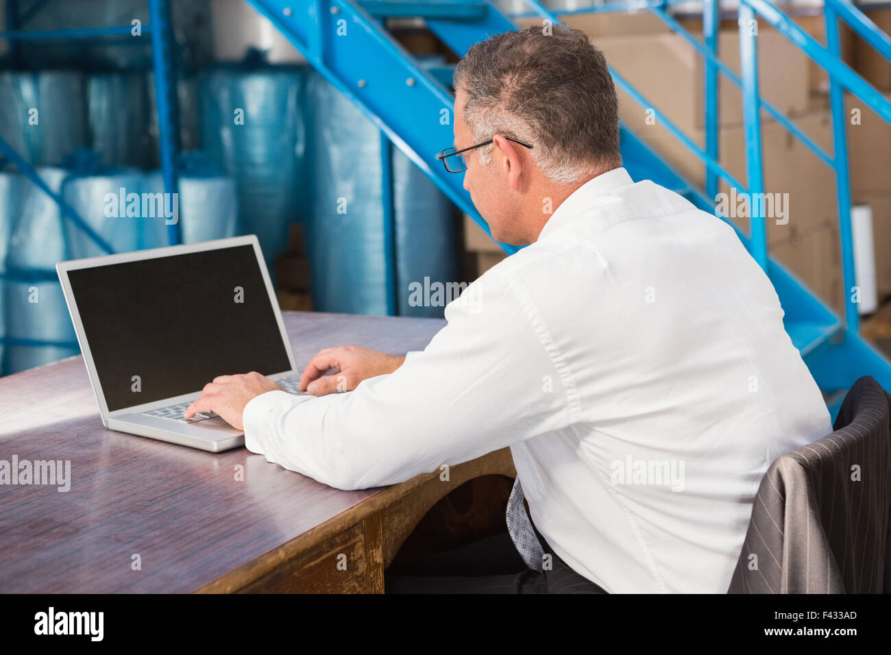 Warehouse manager working on computer Stock Photo - Alamy