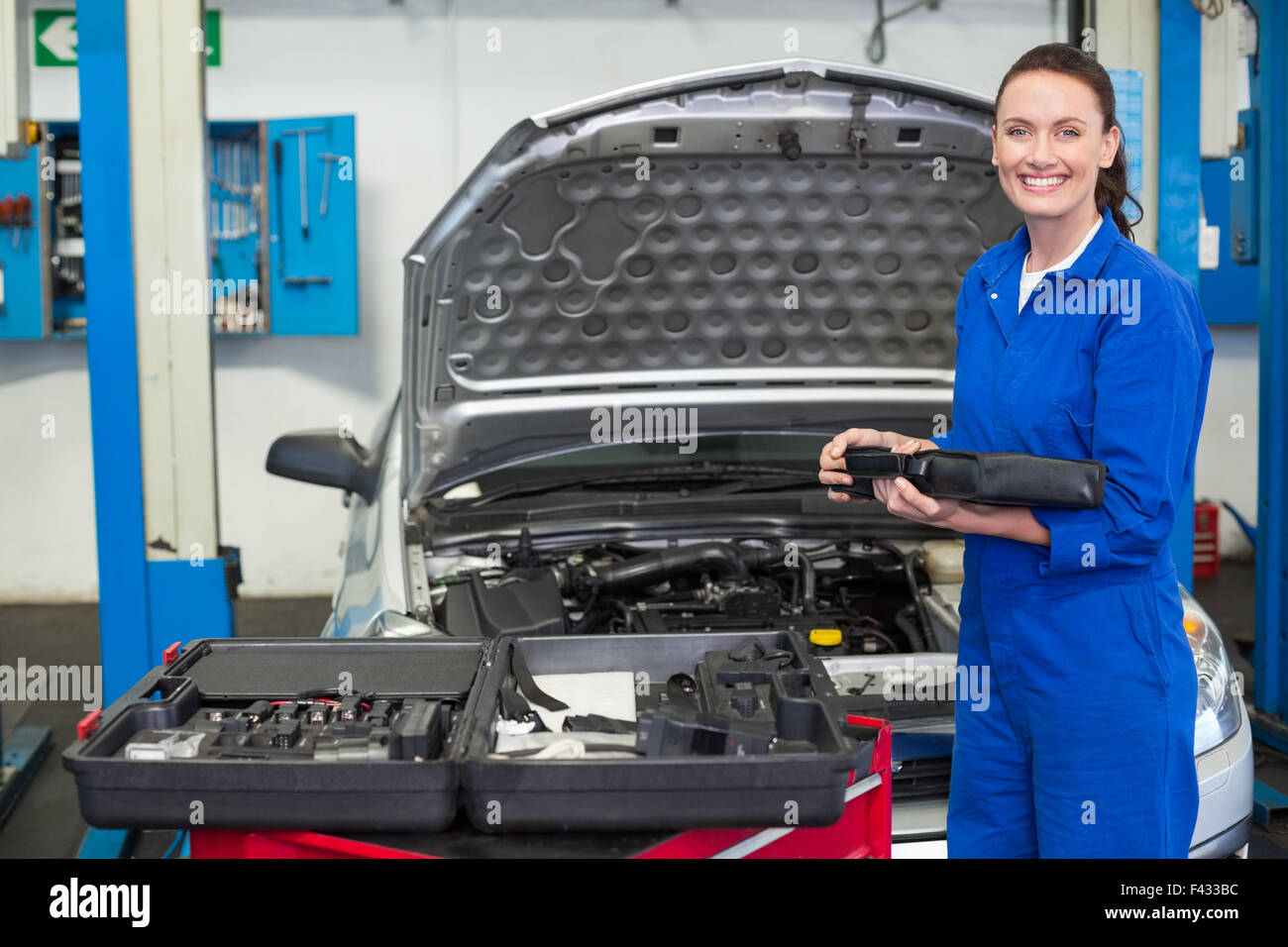 Mechanic smiling at the camera Stock Photo - Alamy
