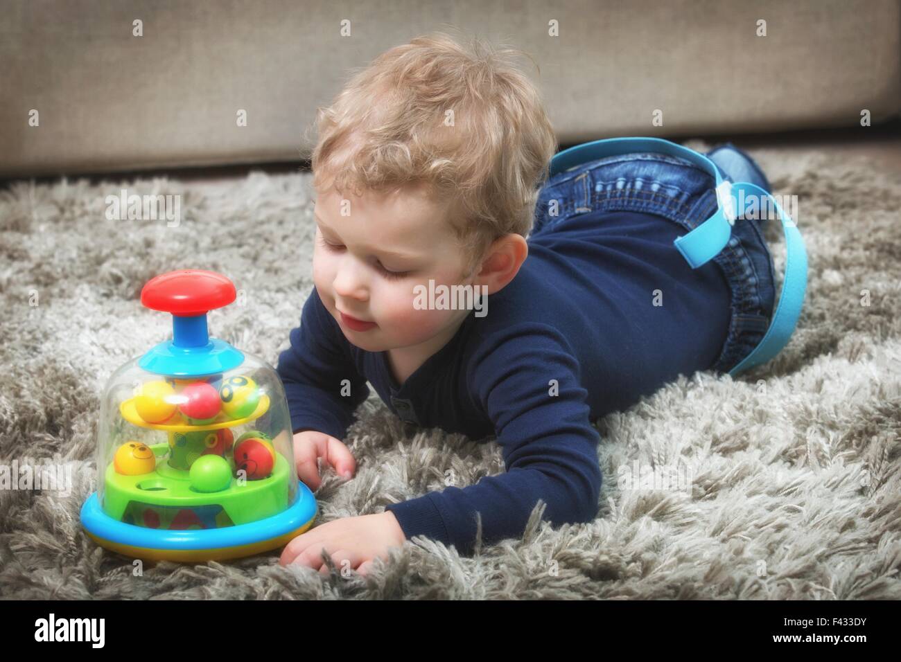 Little boy playing with their favorite toys Stock Photo - Alamy
