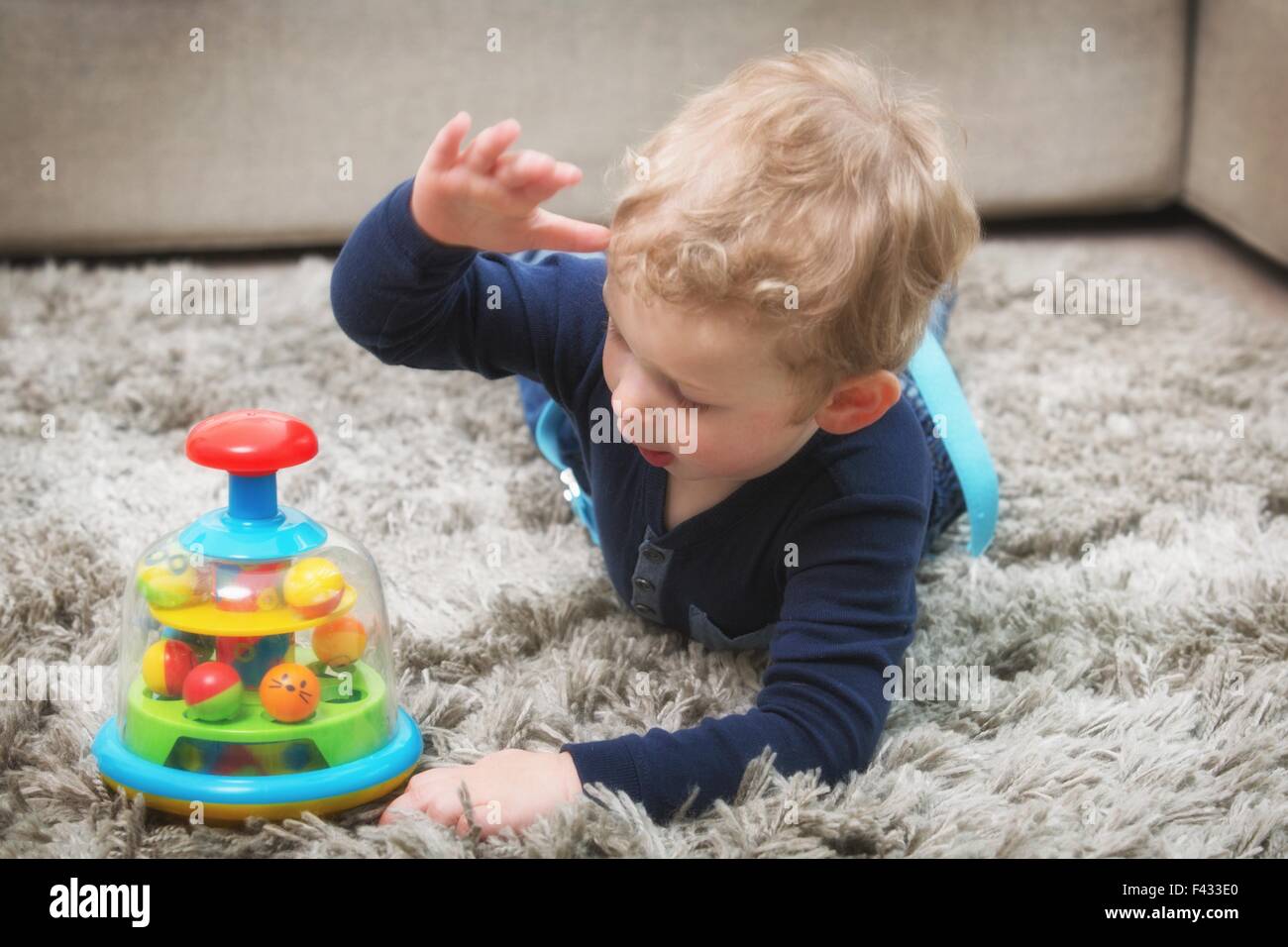 Little boy playing with their favorite toys Stock Photo - Alamy