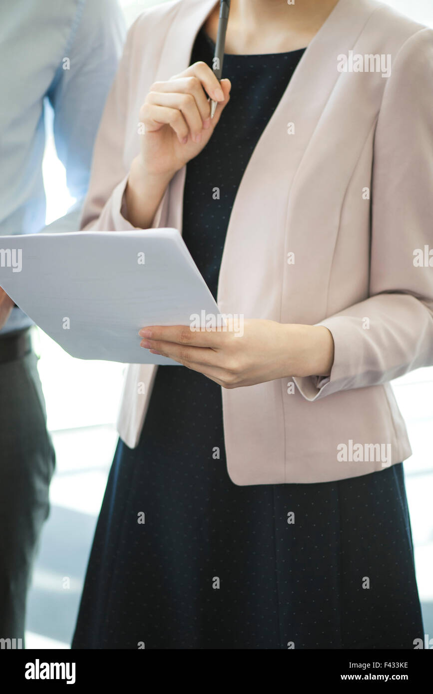 Office worker reviewing document Stock Photo - Alamy
