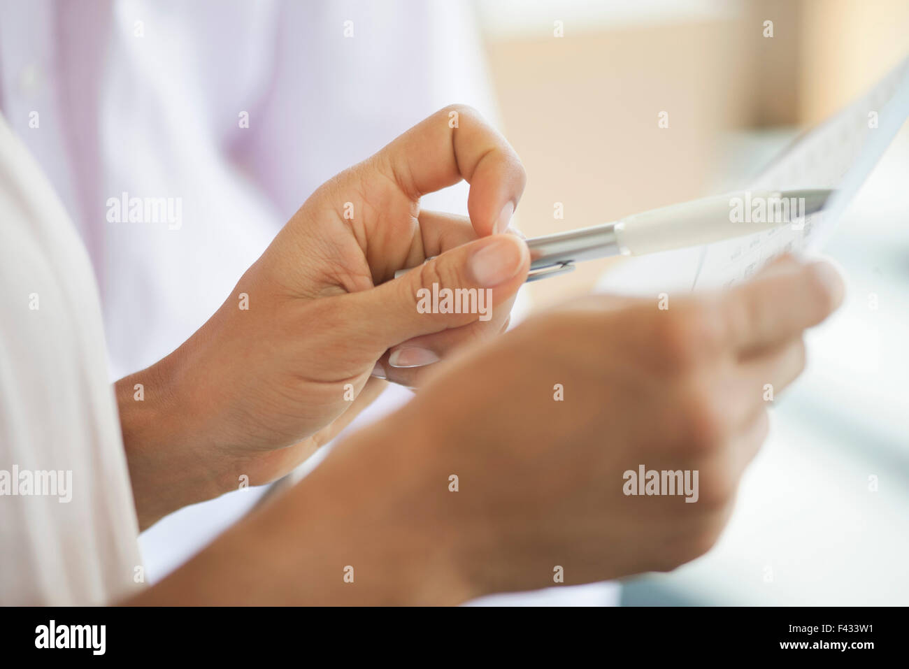 Woman reviewing document Stock Photo - Alamy Woman reviewing document Stock Photo - Alamy