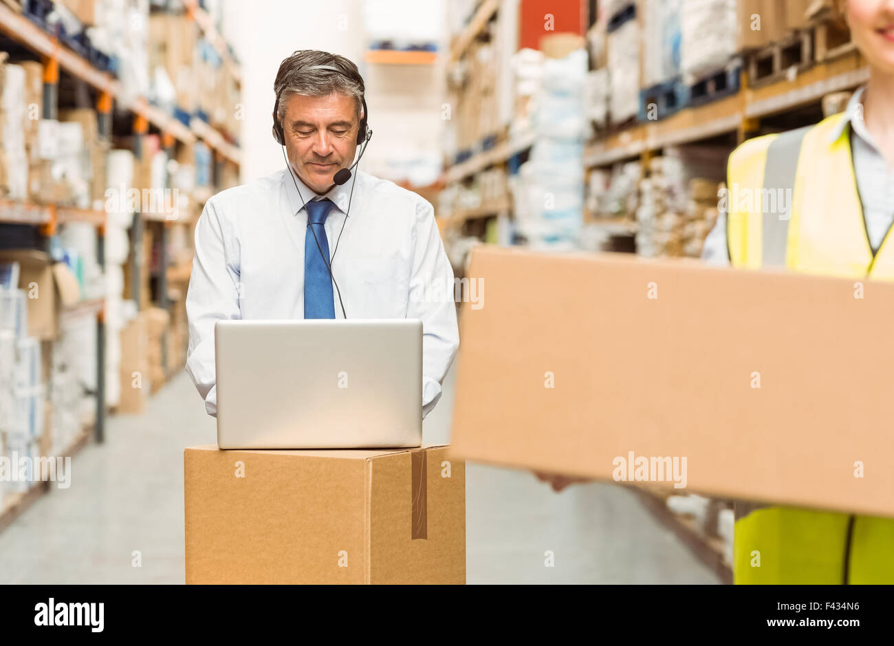 Warehouse manager working on computer Stock Photo - Alamy
