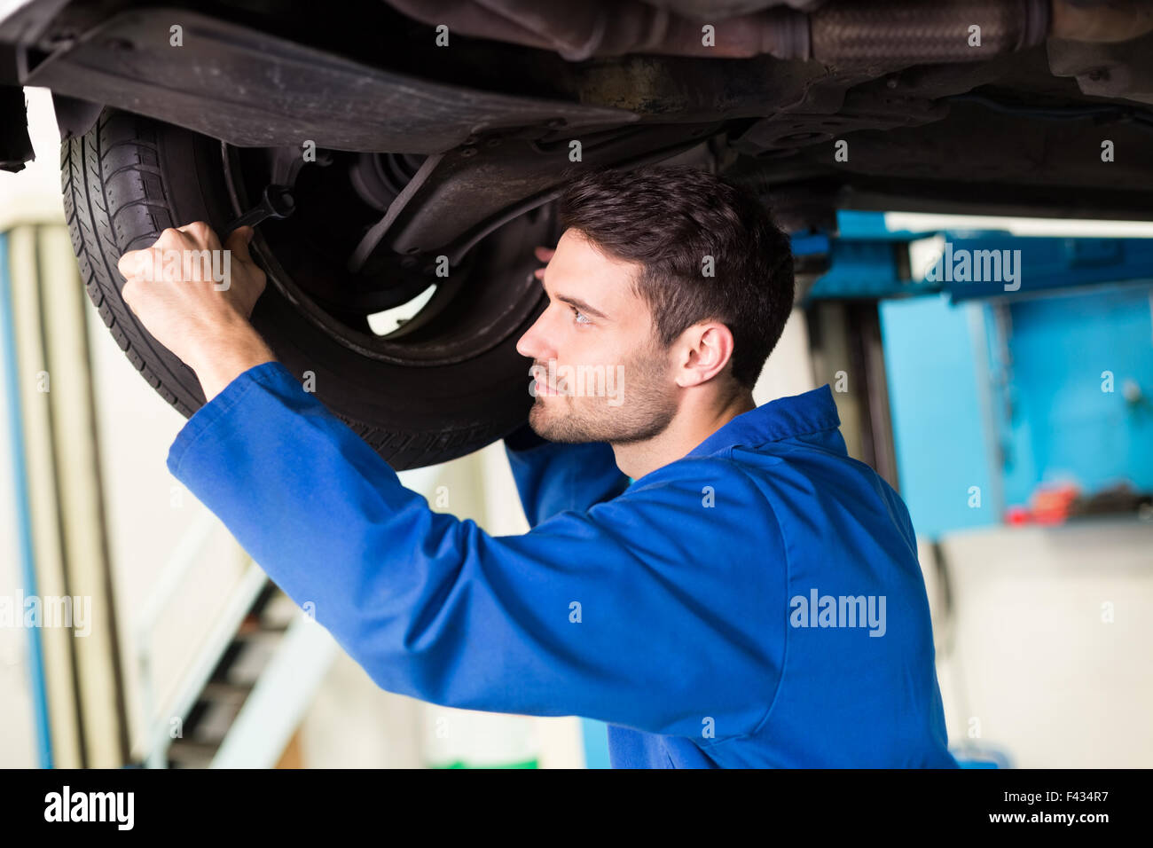 Mechanic adjusting the tire wheel Stock Photo - Alamy