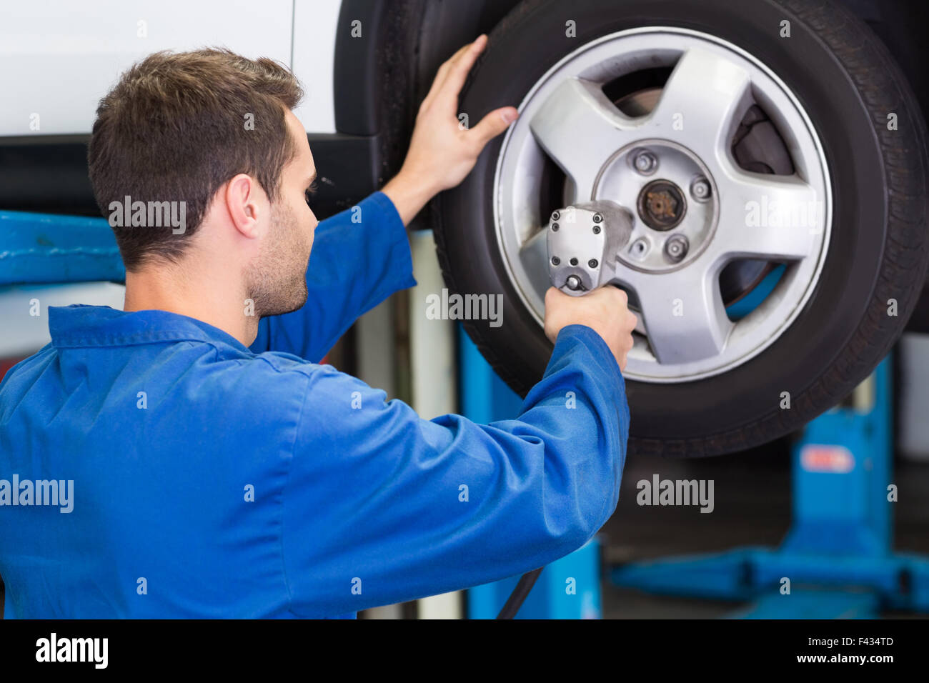 Mechanic adjusting tire wheel hi-res stock photography and images - Alamy