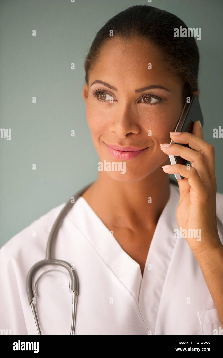 Female nurse using cell phone, portrait Stock Photo - Alamy