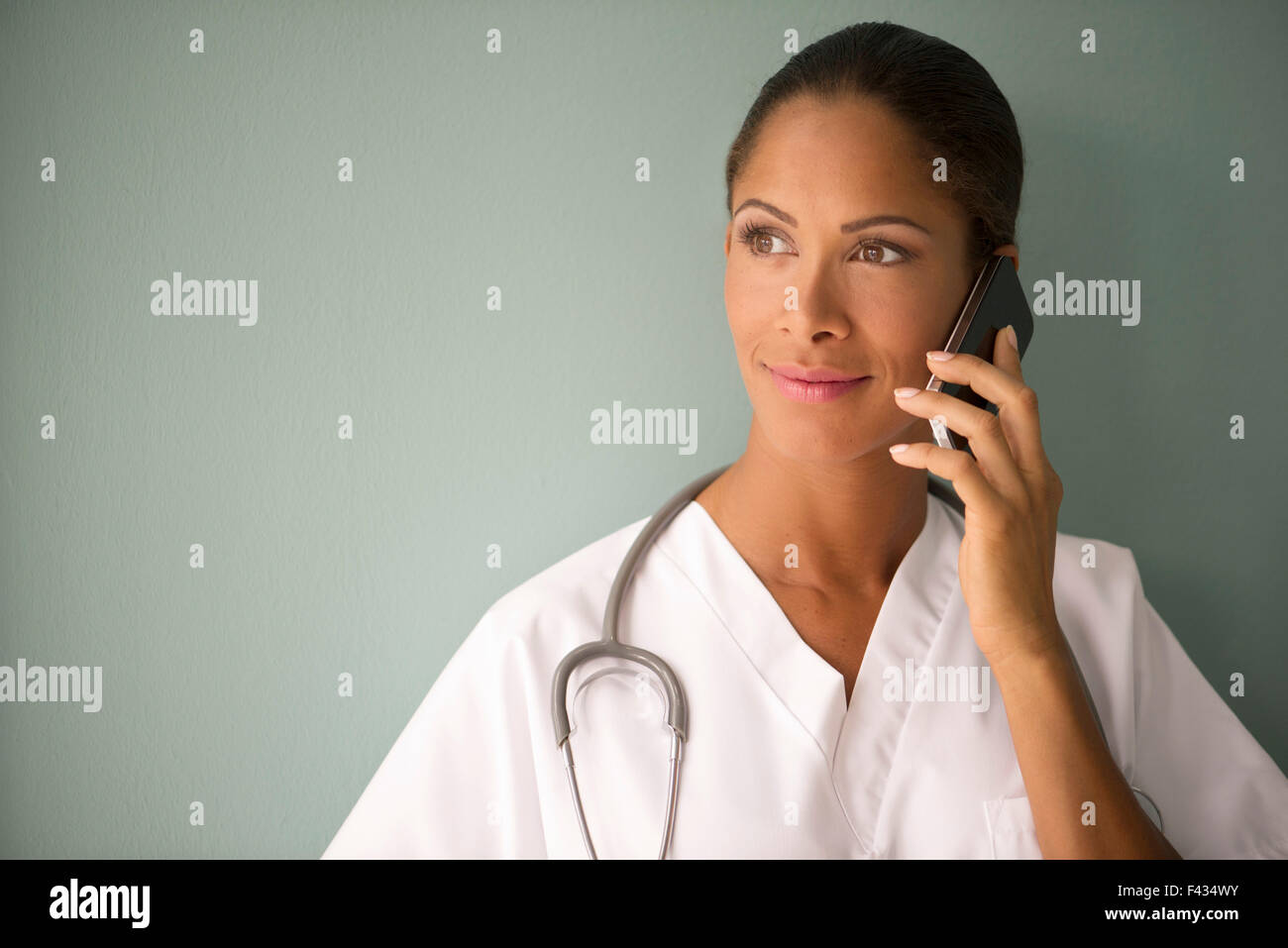 Female doctor using cell phone Stock Photo - Alamy
