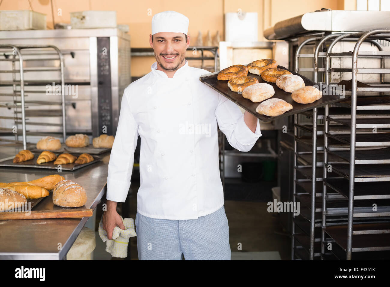Baker holding tray of bread Stock Photo - Alamy